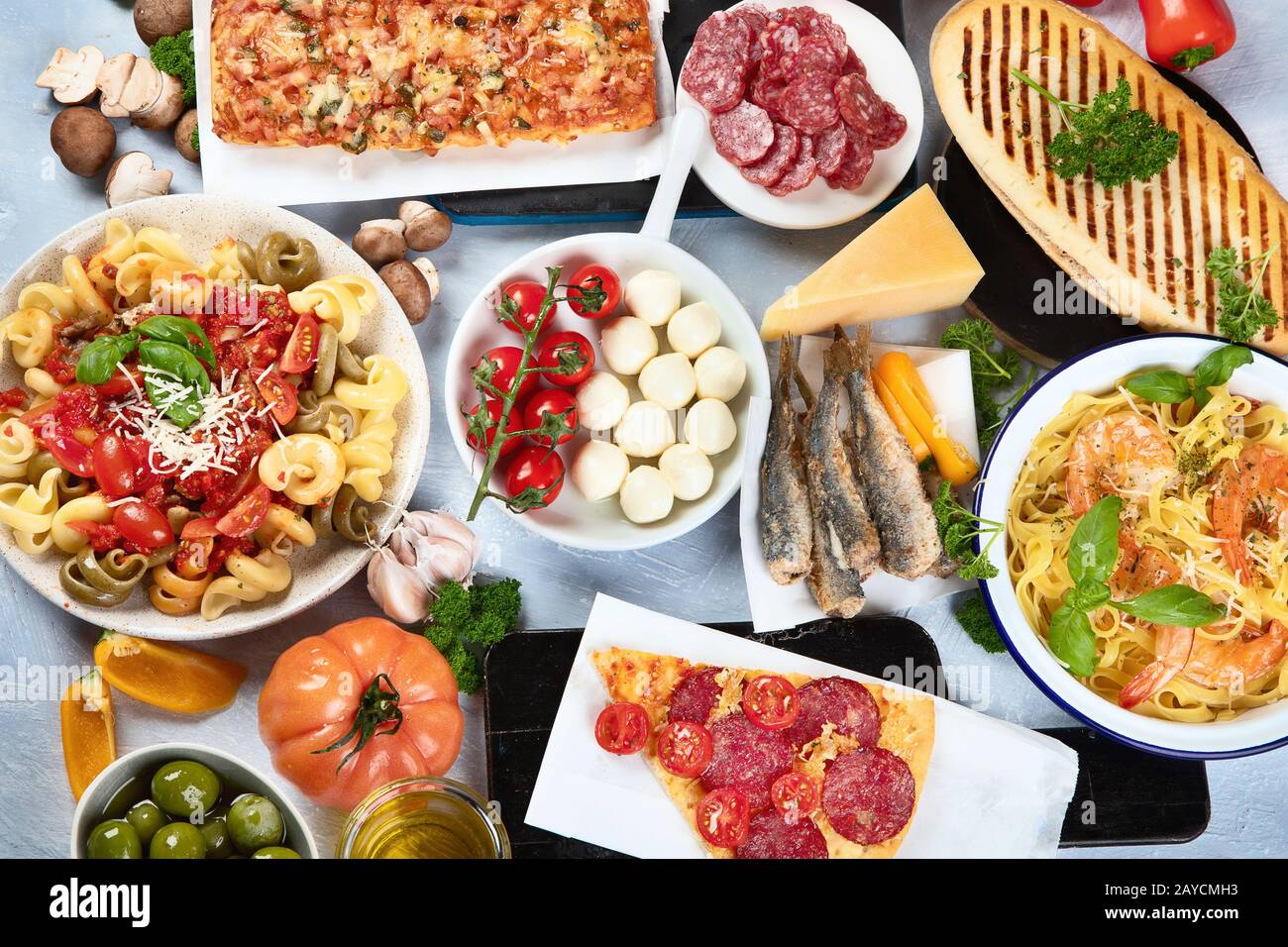 Traditional Italian foods with pizza, pasta, olives, vegetables ...