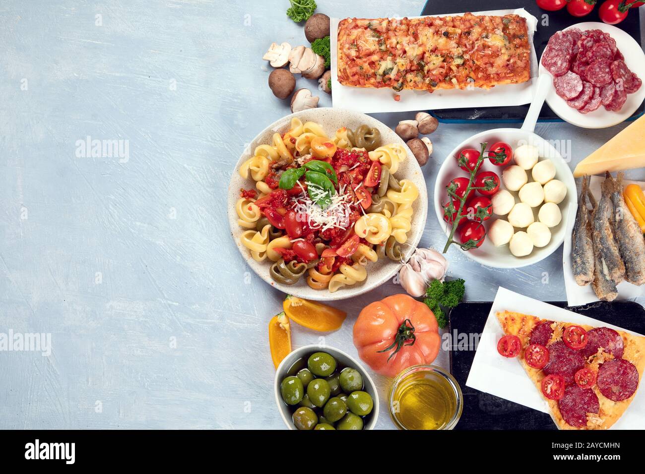 Traditional Italian foods with pizza, pasta, olives, vegetables ...