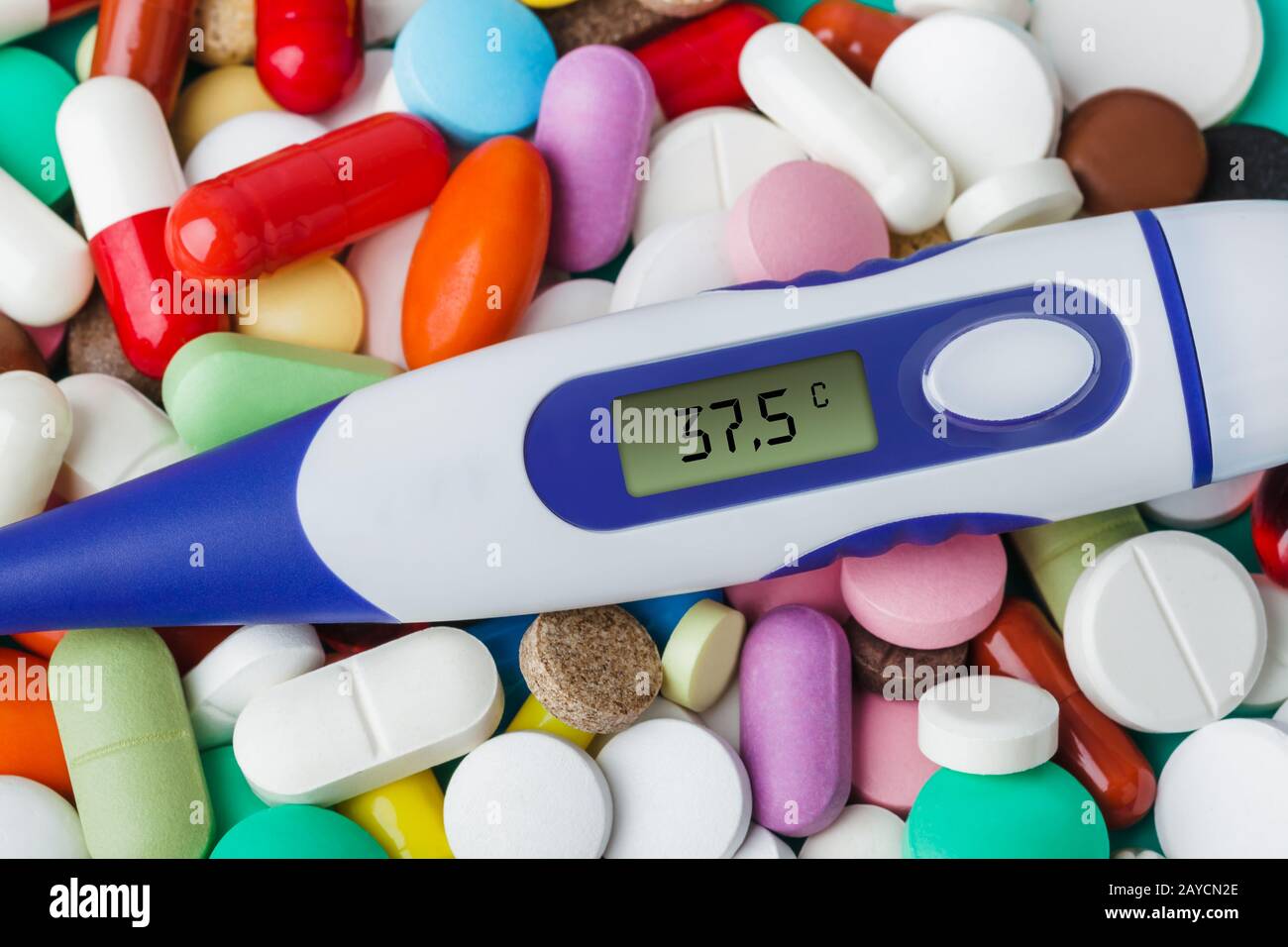 Pills and electronic thermometer (37.5 degrees) - medical background ...