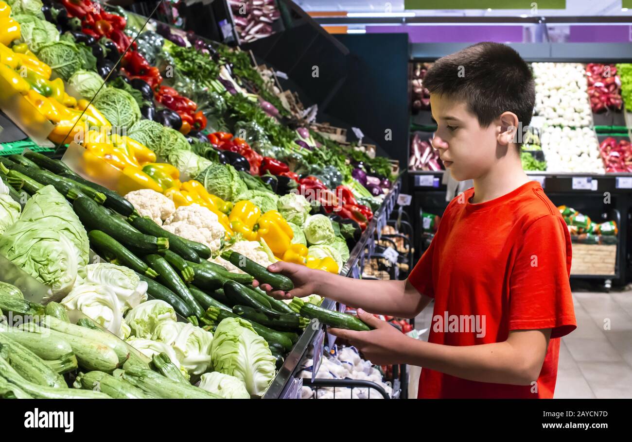 Child selecting vegetables on shelf in supermarket Stock Photo - Alamy