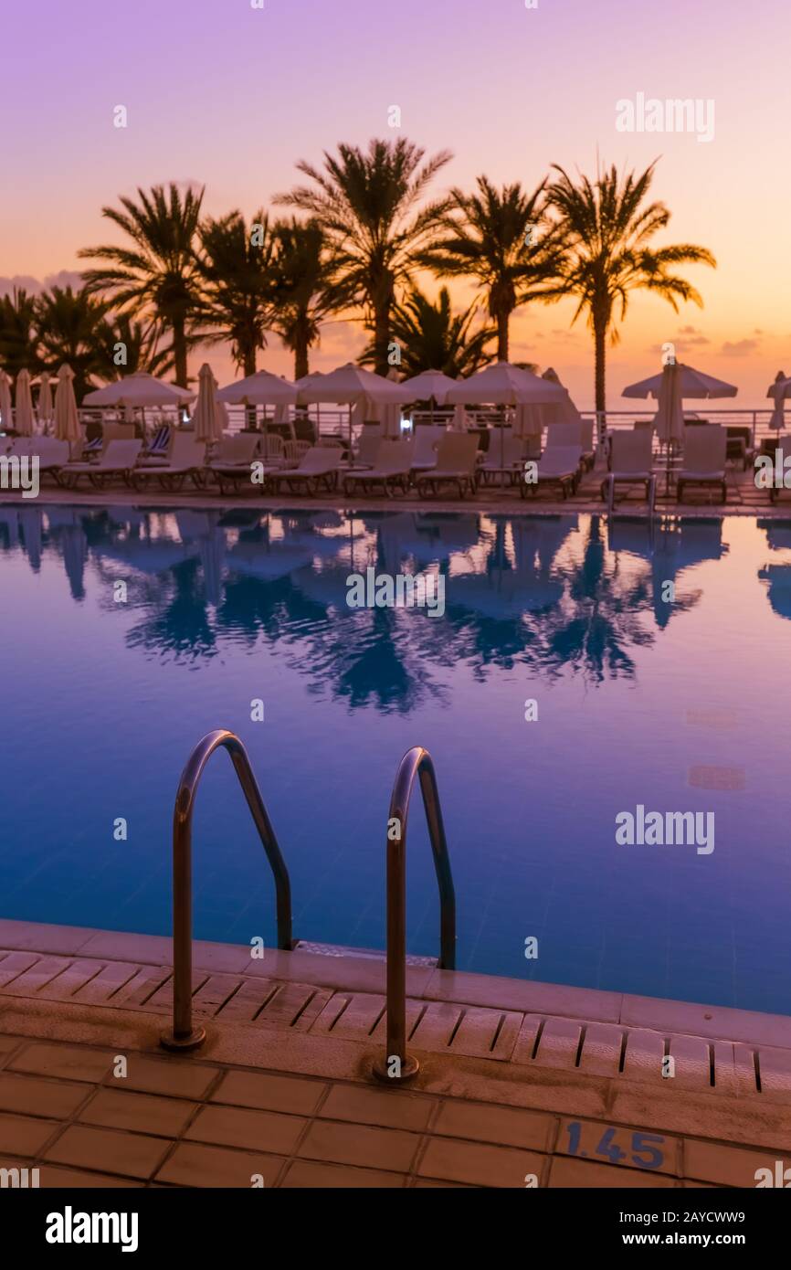 Swimming pool on Cyprus island at sunset Stock Photo - Alamy