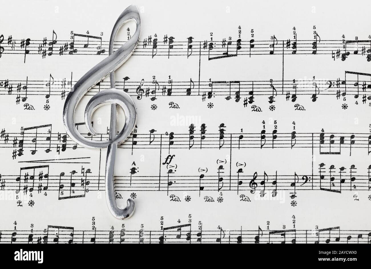 Treble clef on music sheet - musical background Stock Photo - Alamy