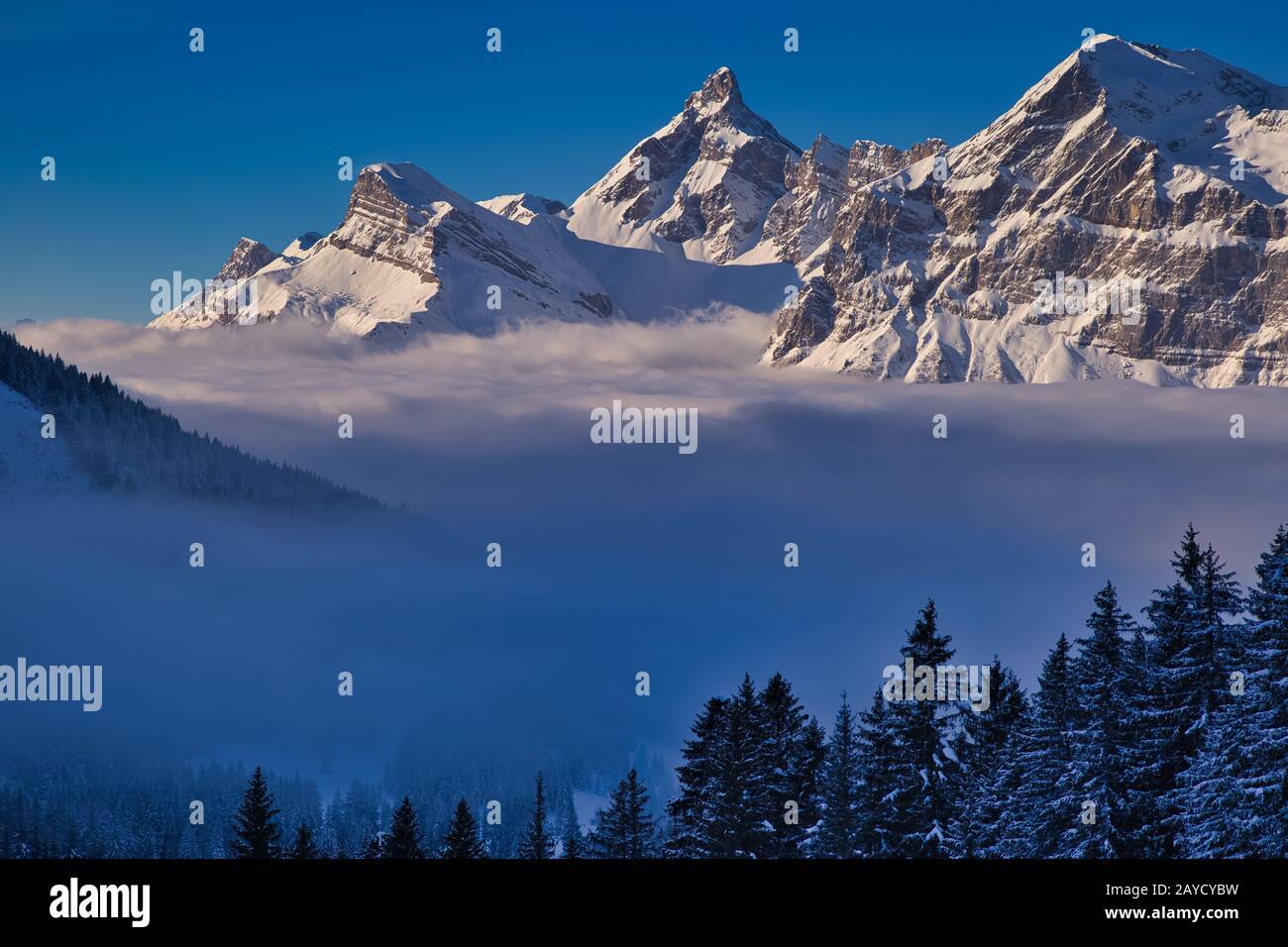 Inversion in valley and illuminated mountain peaks Stock Photo - Alamy