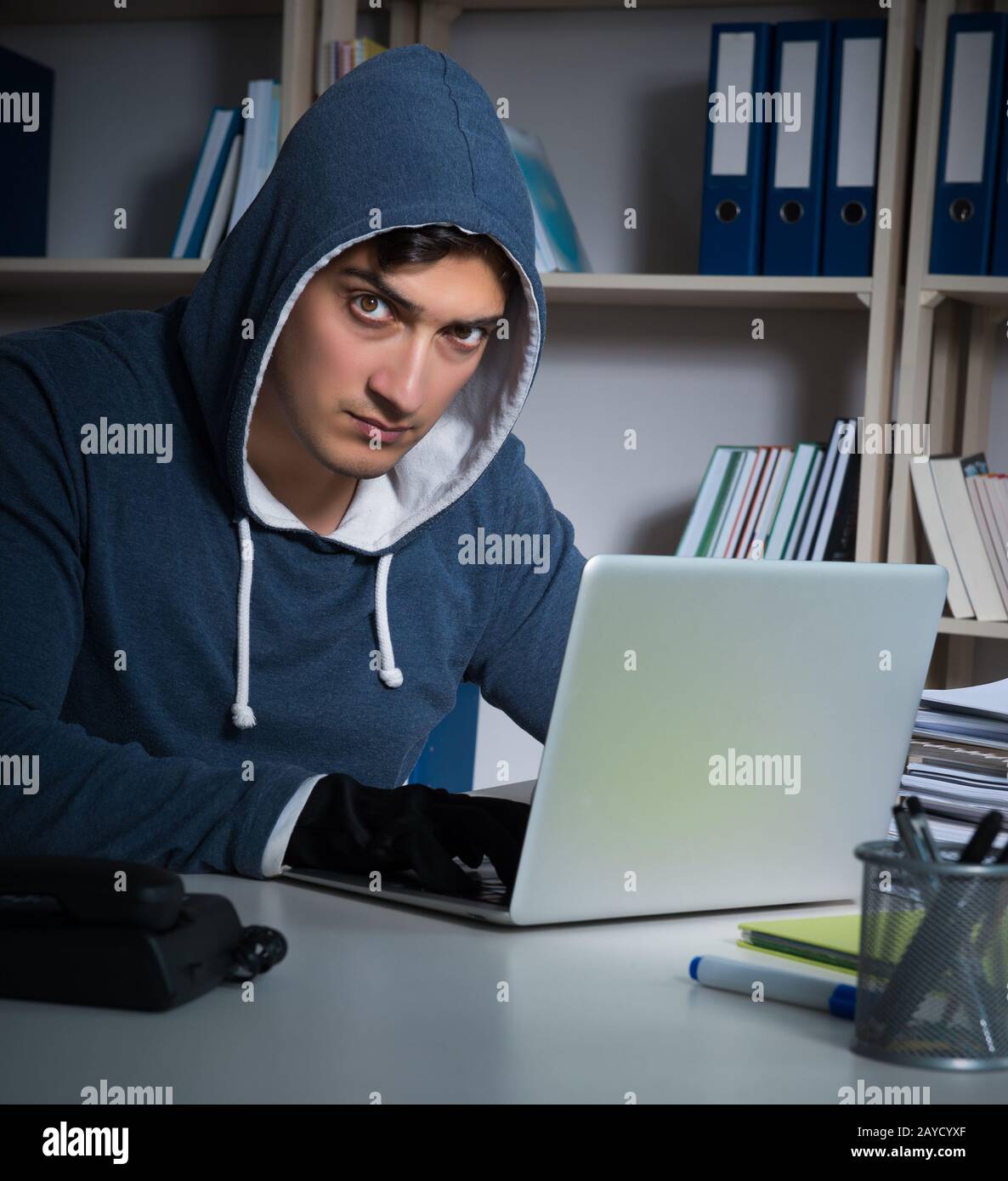 Young hacker hacking into computer at night Stock Photo - Alamy