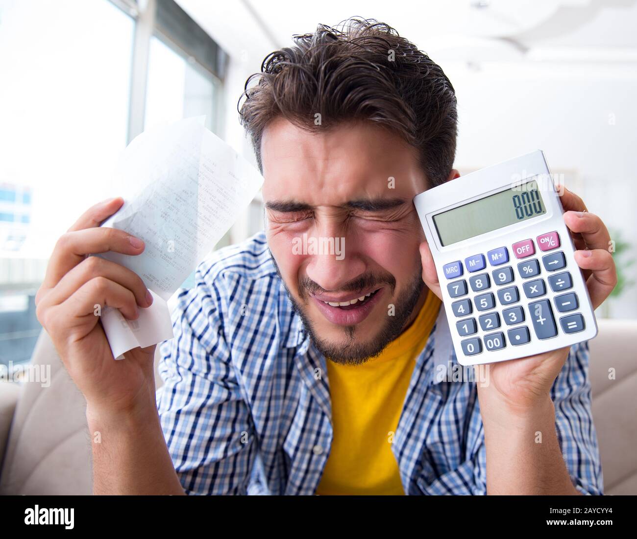 Man angry at bills he needs to pay Stock Photo - Alamy