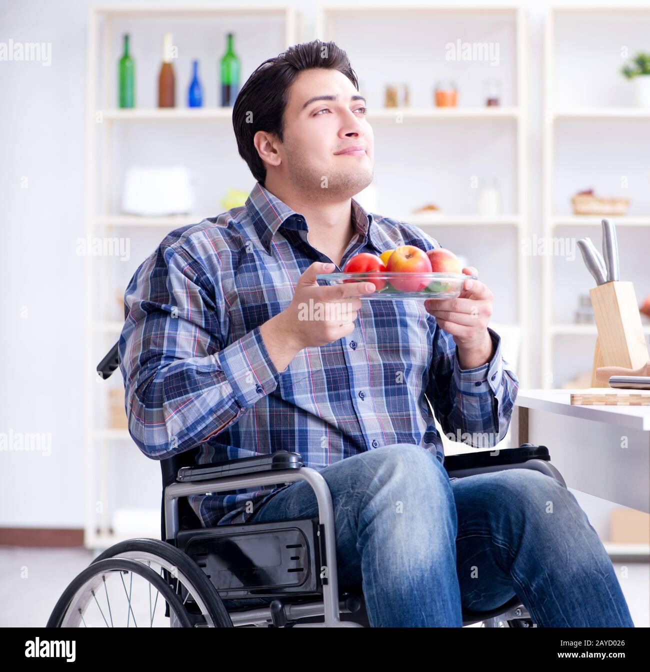 Young disabled husband preparing food salad Stock Photo - Alamy