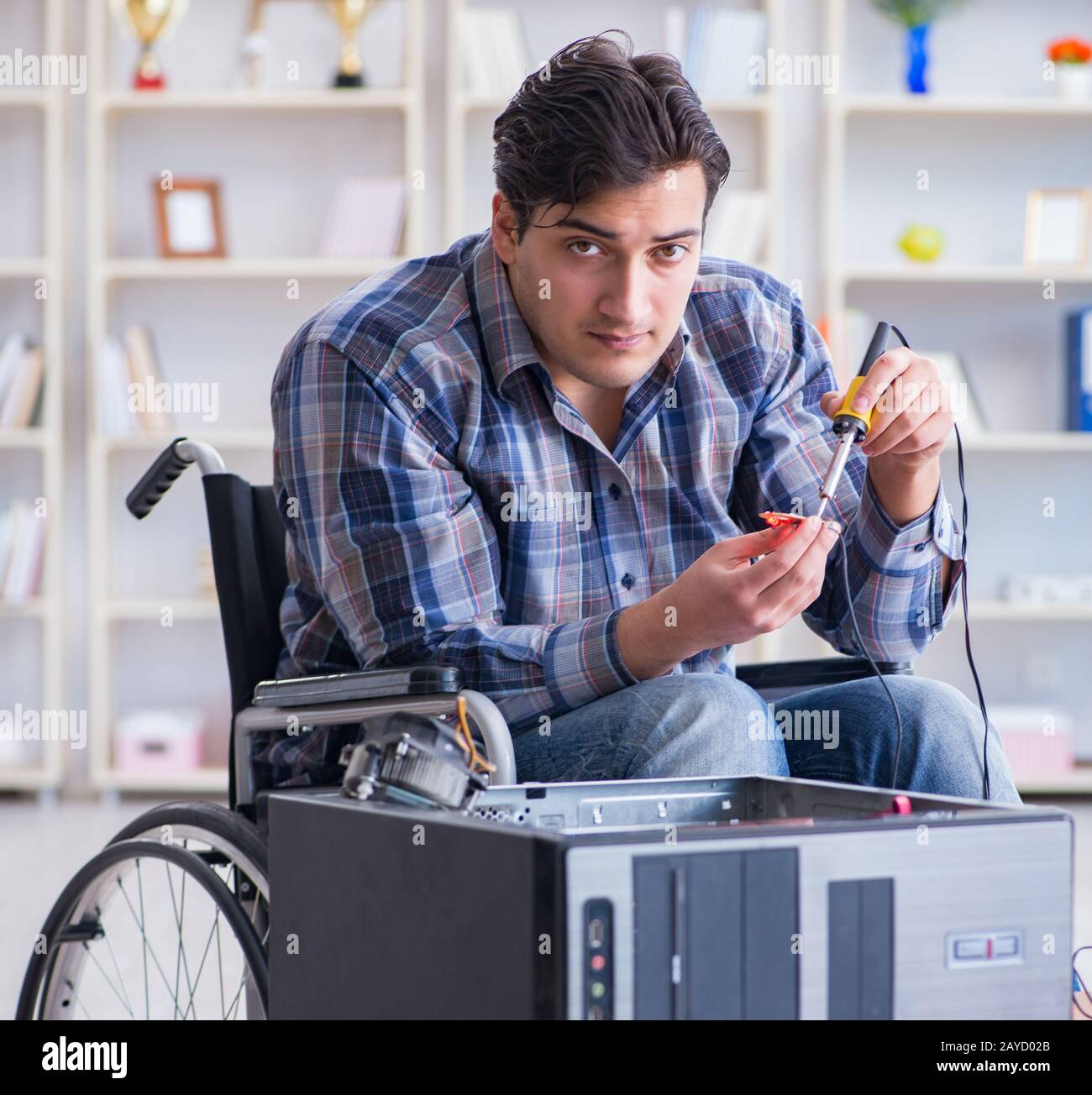 Computer repairman on wheelchair working Stock Photo - Alamy