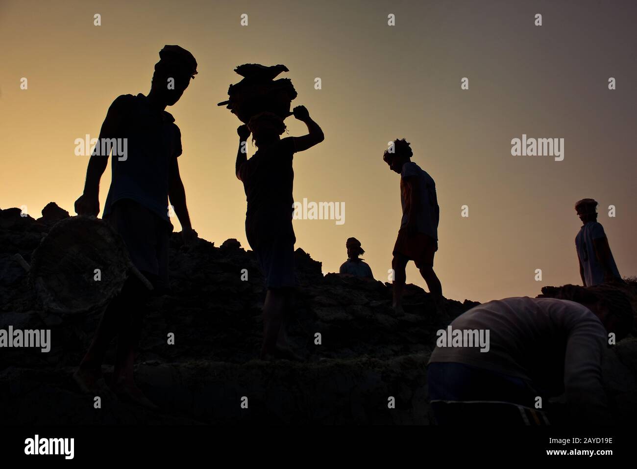 A day labourer carries a basket of soil on his head. Khulna, Bangladesh ...