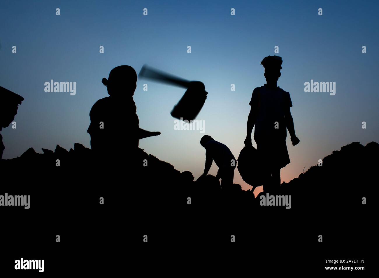 A day labourer carries a basket of soil on his head. Khulna, Bangladesh ...