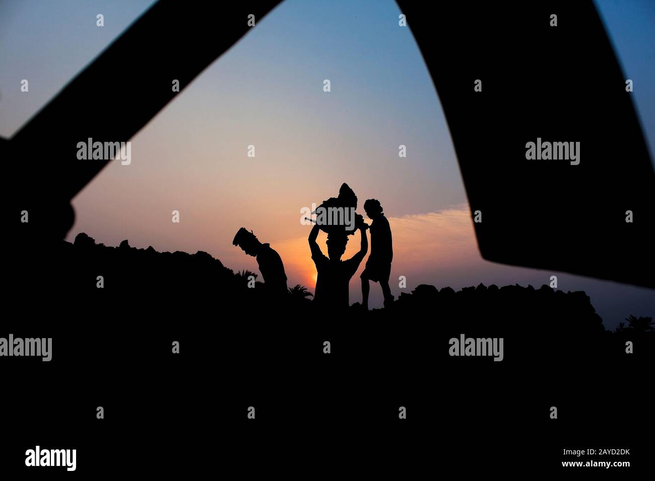 A day labourer carries a basket of soil on his head. Khulna, Bangladesh ...