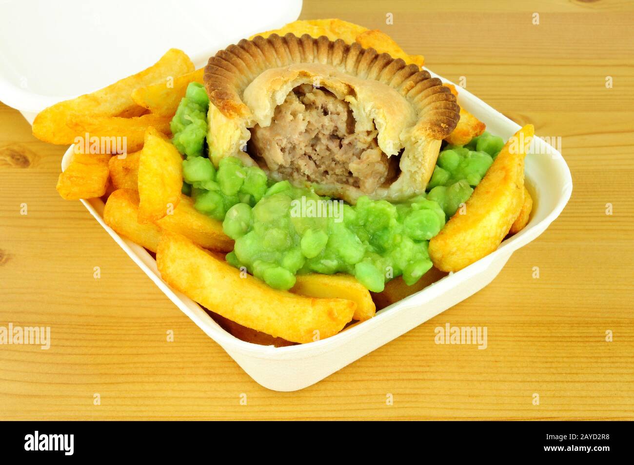 Meat pie and chips with mushy peas in a take away box Stock Photo - Alamy