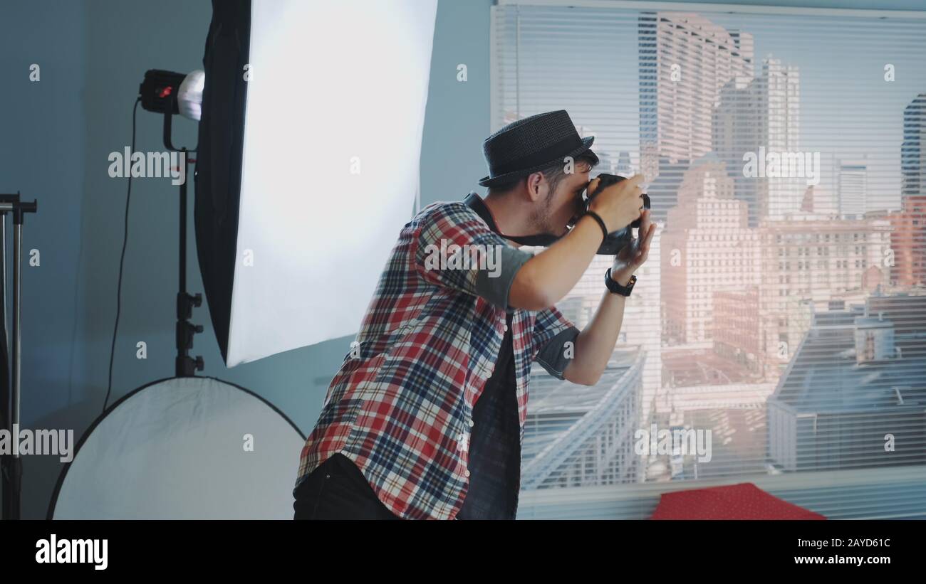 Young photographer in casual clothes explaining something and starting ...