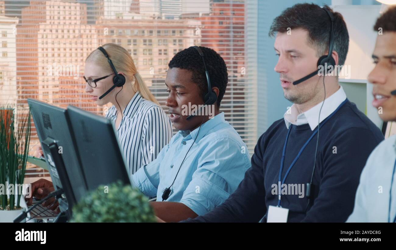 African customer service representative working on multiracial team of ...