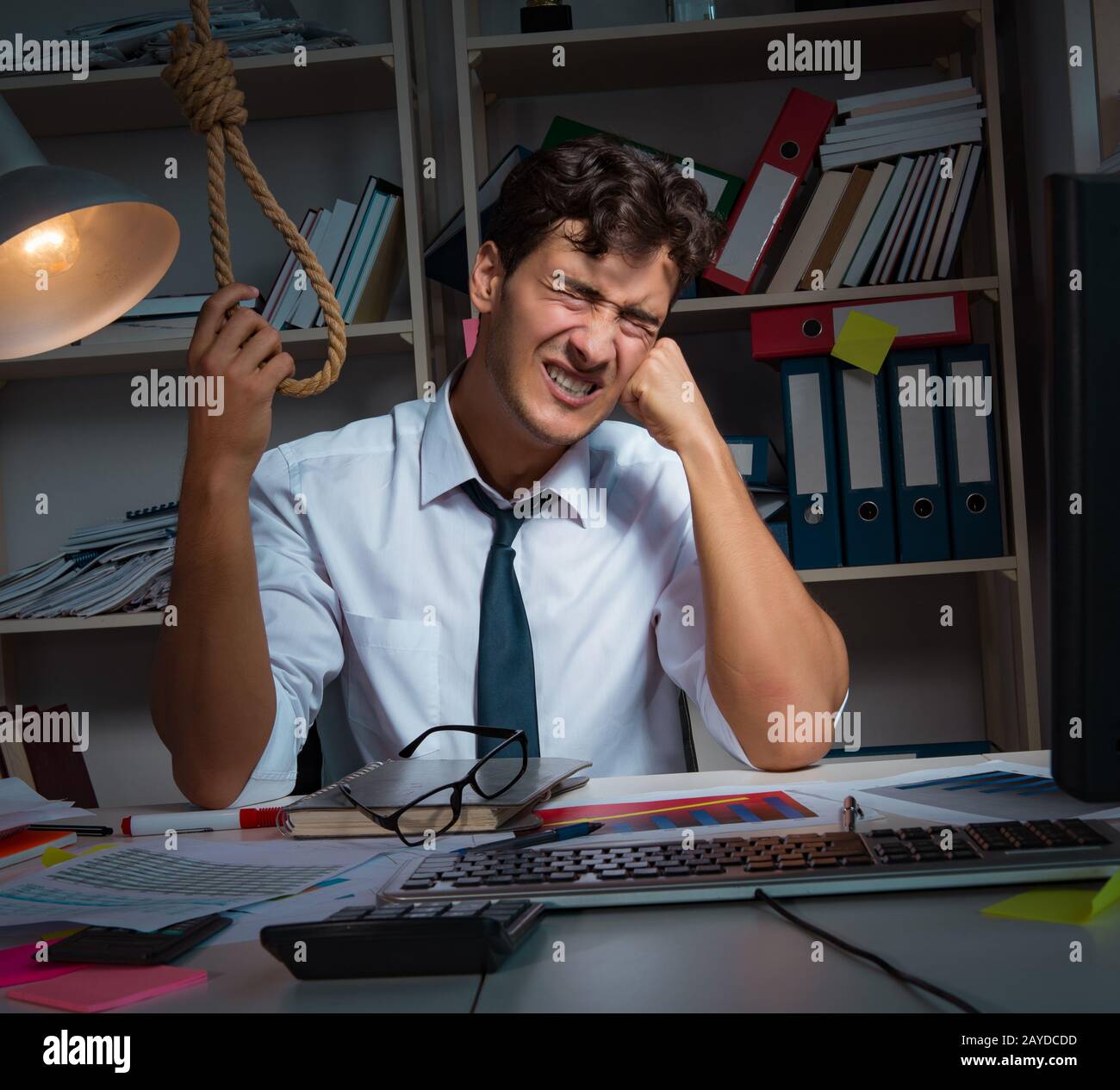 Man businessman working late hours in the office Stock Photo - Alamy