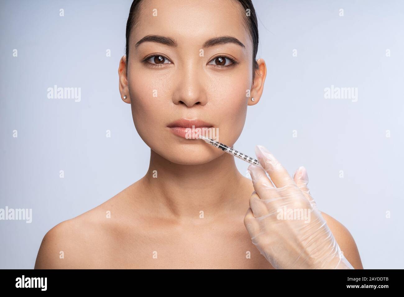 Beautiful female doing injection for lip augmentation Stock Photo - Alamy