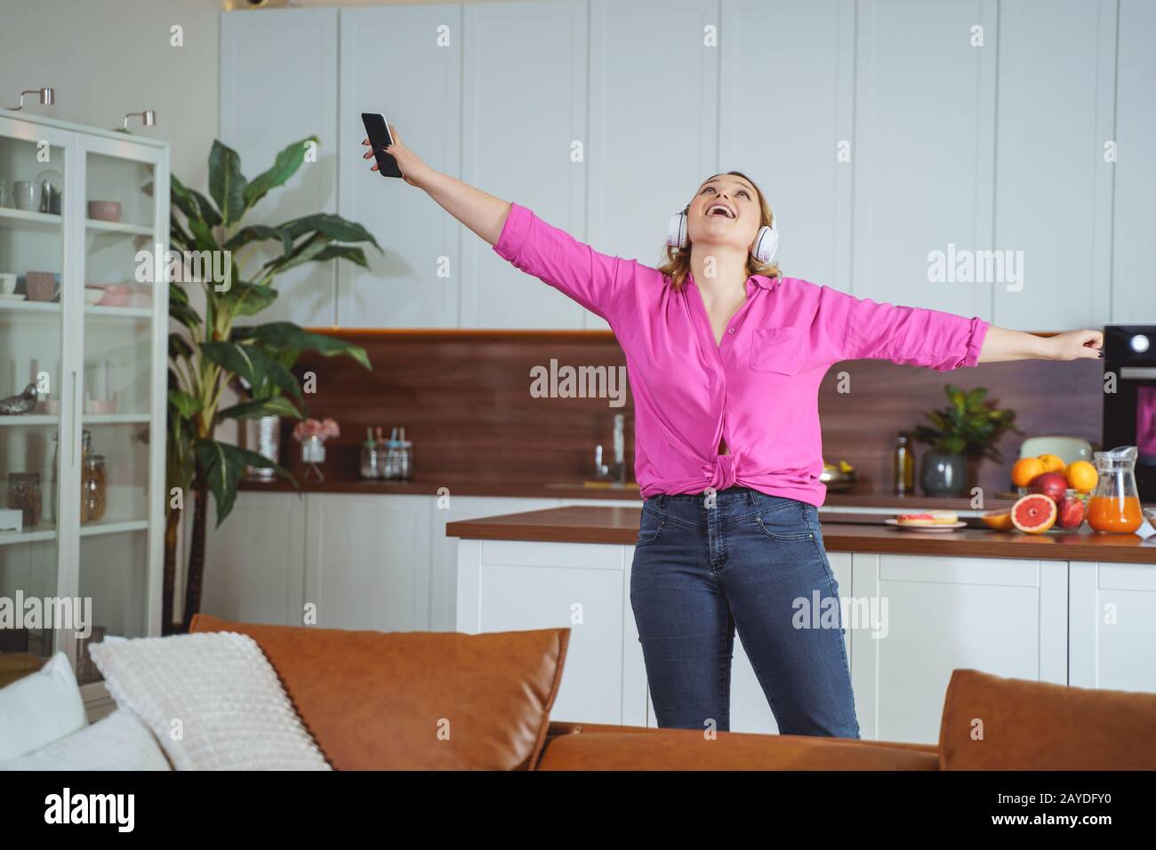 Positive delighted woman dancing in the kitchen Stock Photo - Alamy