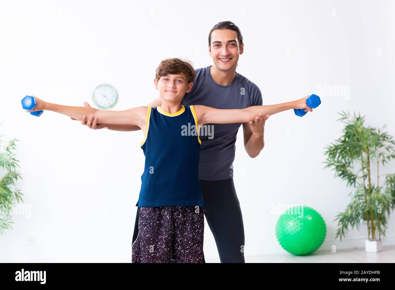 Young father and his son doing exercises Stock Photo - Alamy