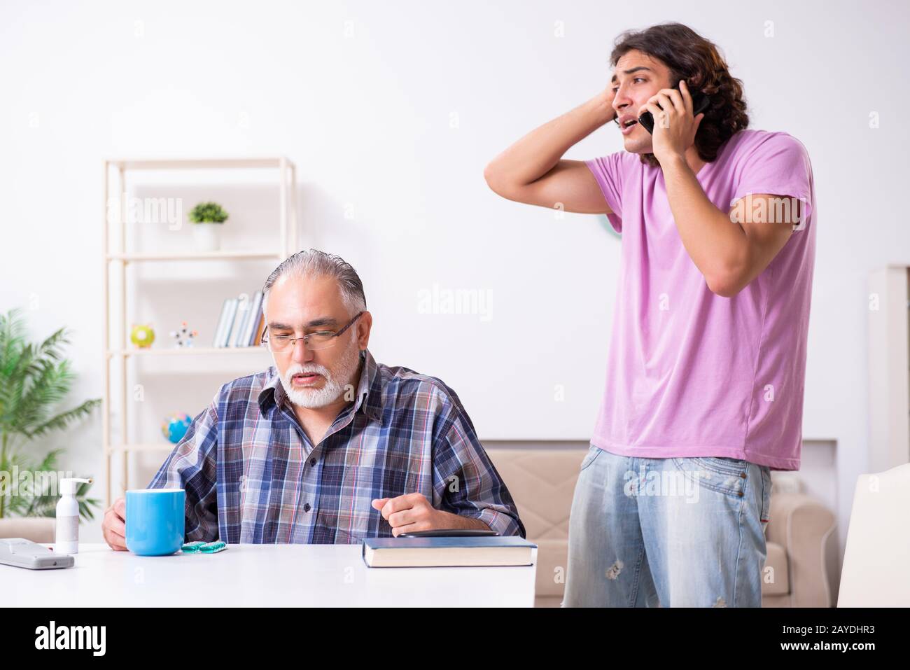 Young student and his old grandpa at home Stock Photo - Alamy