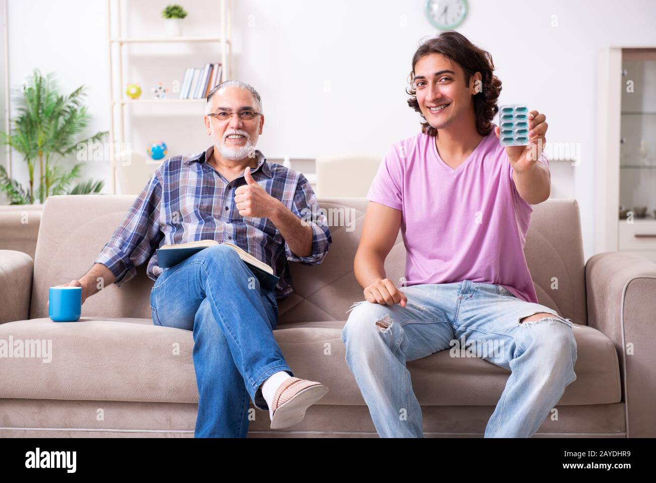 Young student and his old grandpa at home Stock Photo - Alamy