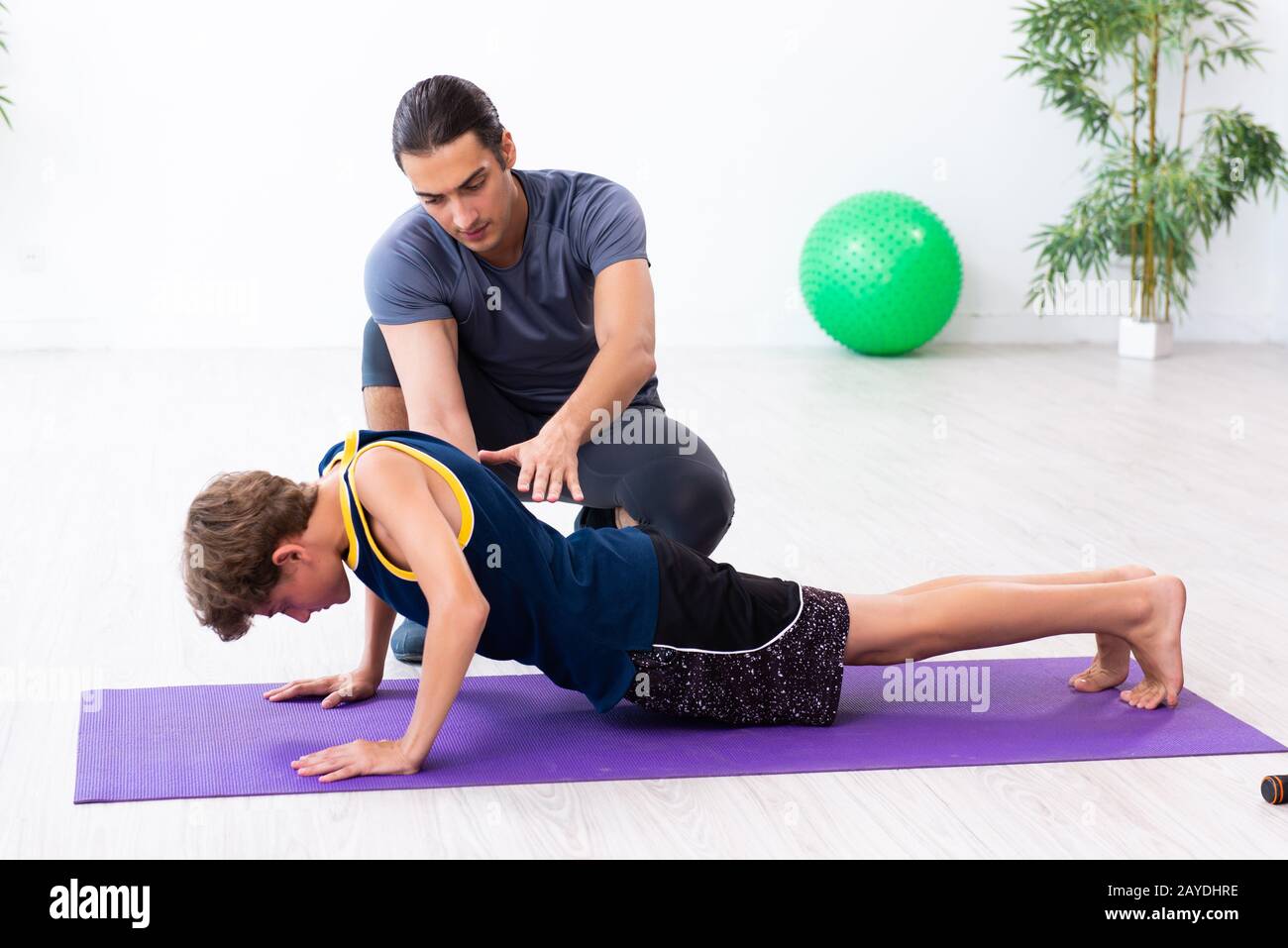 Young father and his son doing exercises Stock Photo - Alamy