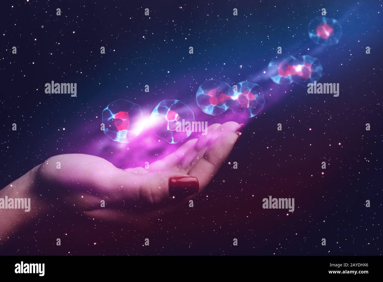 Human hand holding cell dividing. nebula dust. Mixed media Stock Photo ...