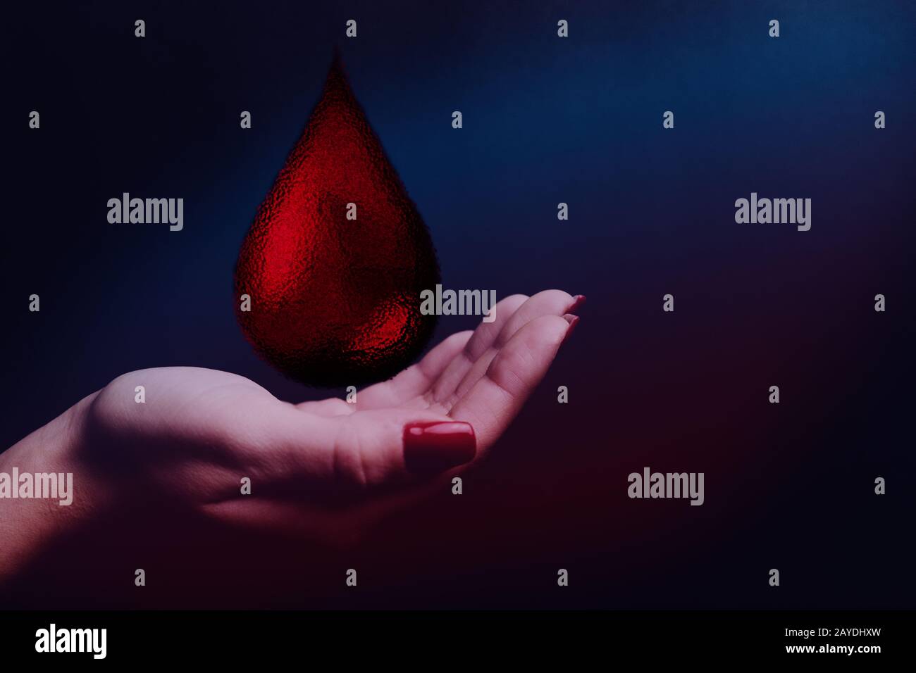 Human hand blood drop. Nebula dust in infinite space. World Blood Donor ...