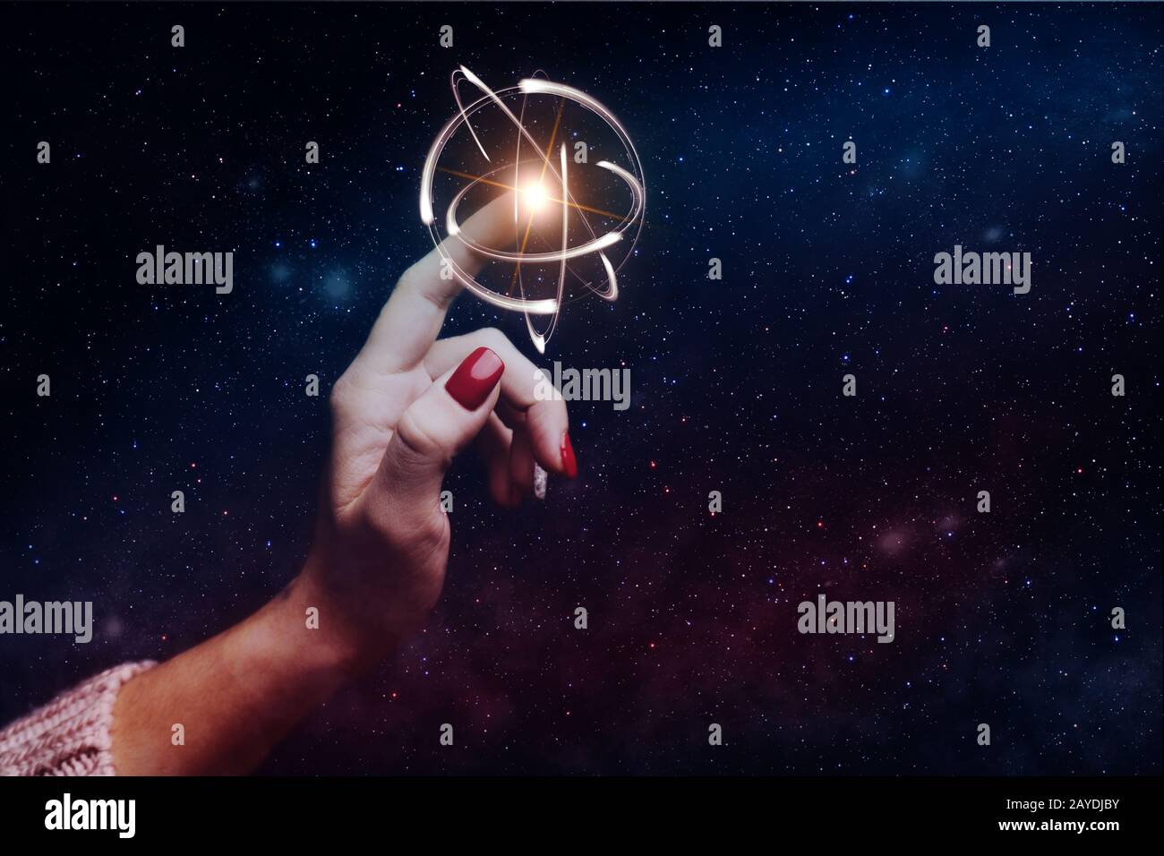 Human forefinger touches atom. Nebula dust in infinite space. Mixed ...
