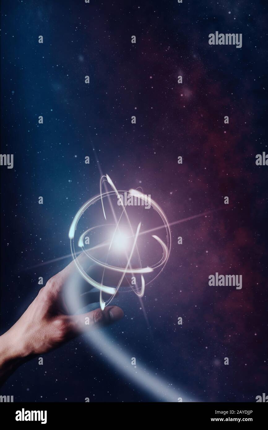 Human forefinger touches atom. Nebula dust in infinite space. Mixed ...