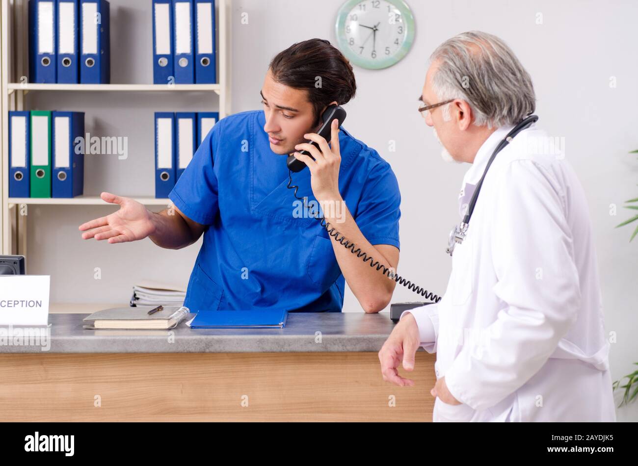 Two doctors talking at the reception in hospital Stock Photo - Alamy