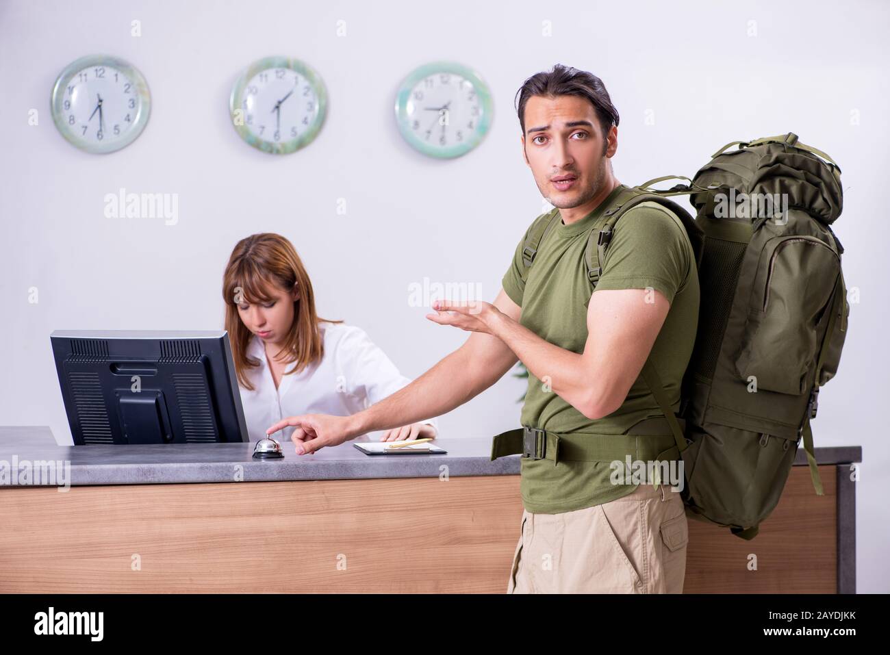Young man at the hotel reception Stock Photo - Alamy