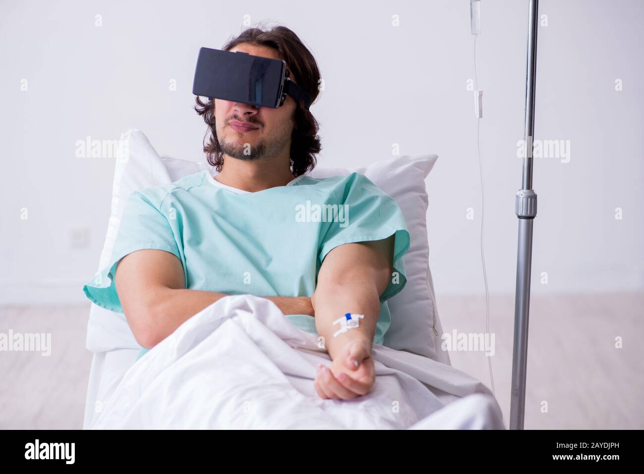 Young man staying in hospital in transfusion concept Stock Photo - Alamy