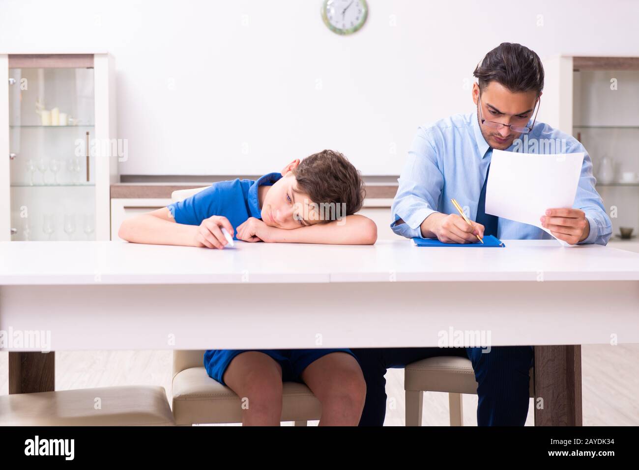 Busy father helping his son to prepare for exam Stock Photo - Alamy