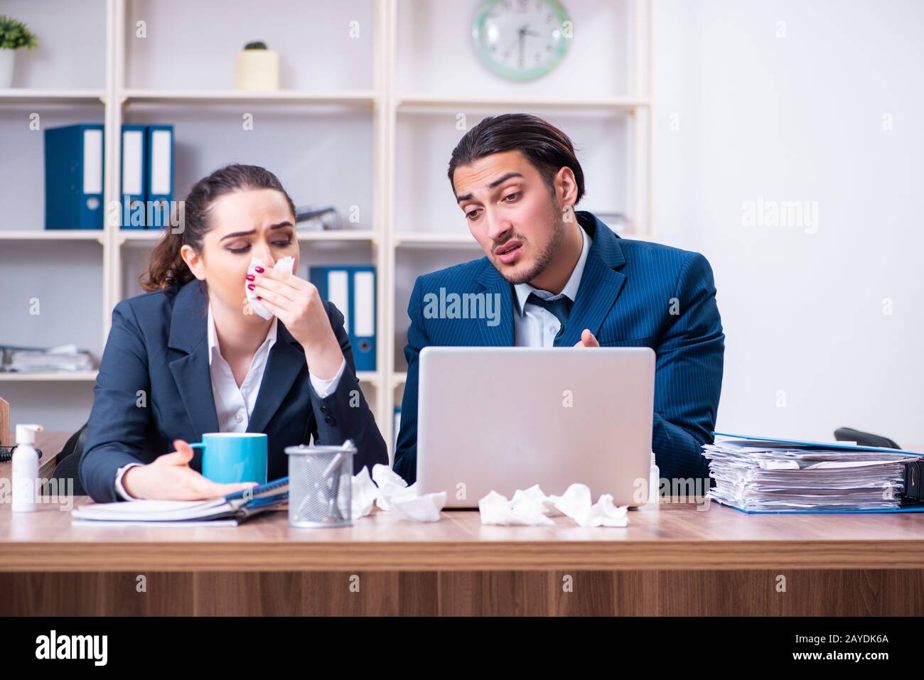 Two employees suffering at workplace Stock Photo - Alamy