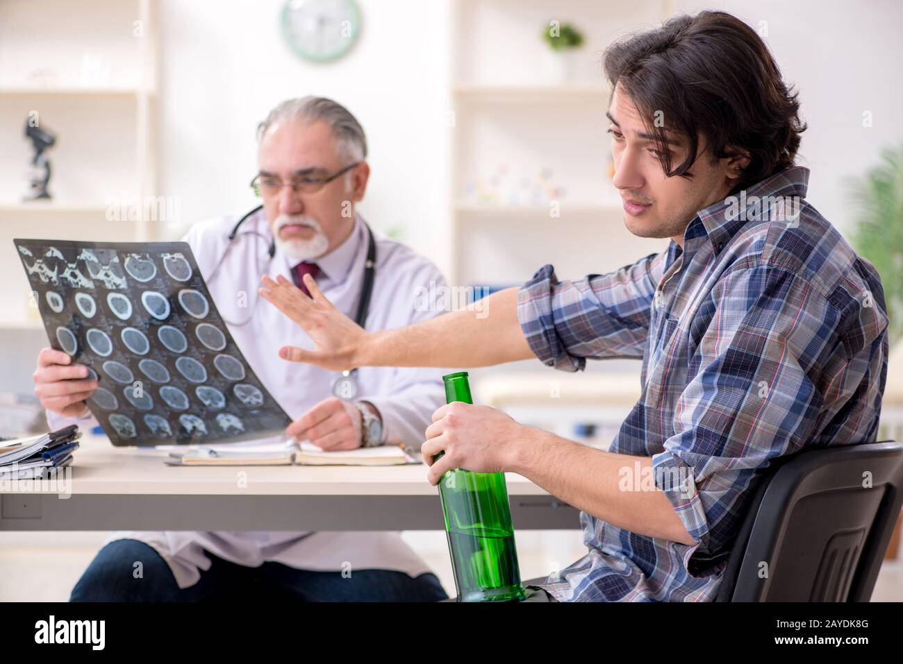 Young male alcoholic visiting old doctor Stock Photo - Alamy