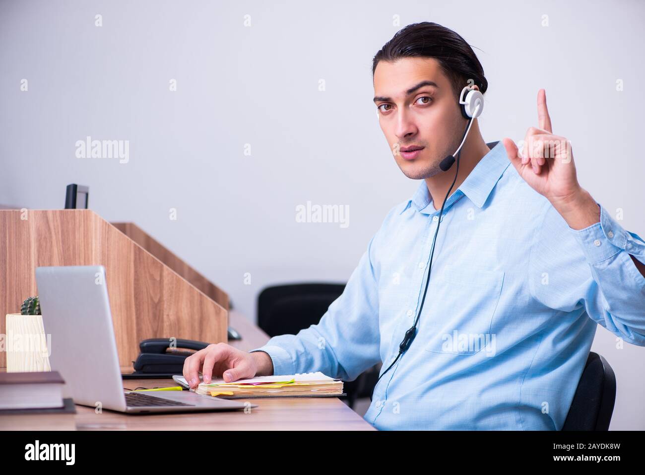 Call center operator working at his desk Stock Photo - Alamy