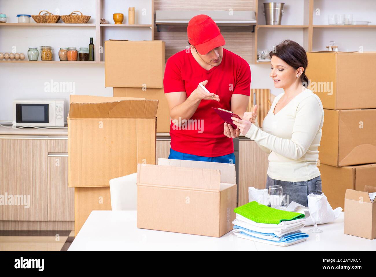 Young male contractor and female customer in moving concept Stock Photo ...