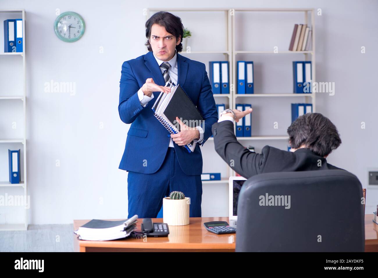 Boss and his male assistant working in the office Stock Photo - Alamy