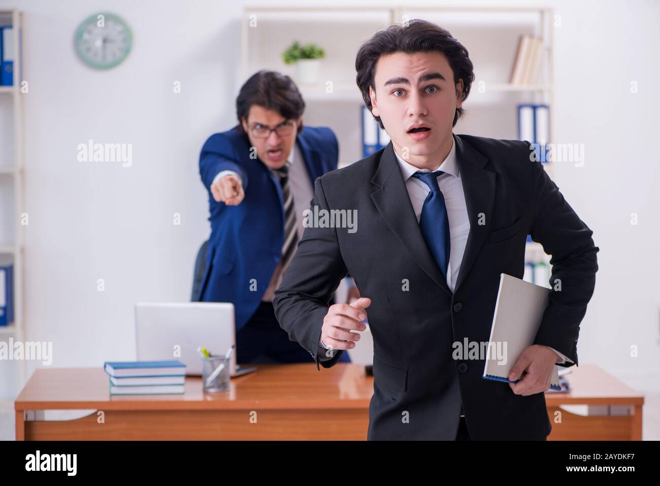 Boss and his male assistant working in the office Stock Photo - Alamy