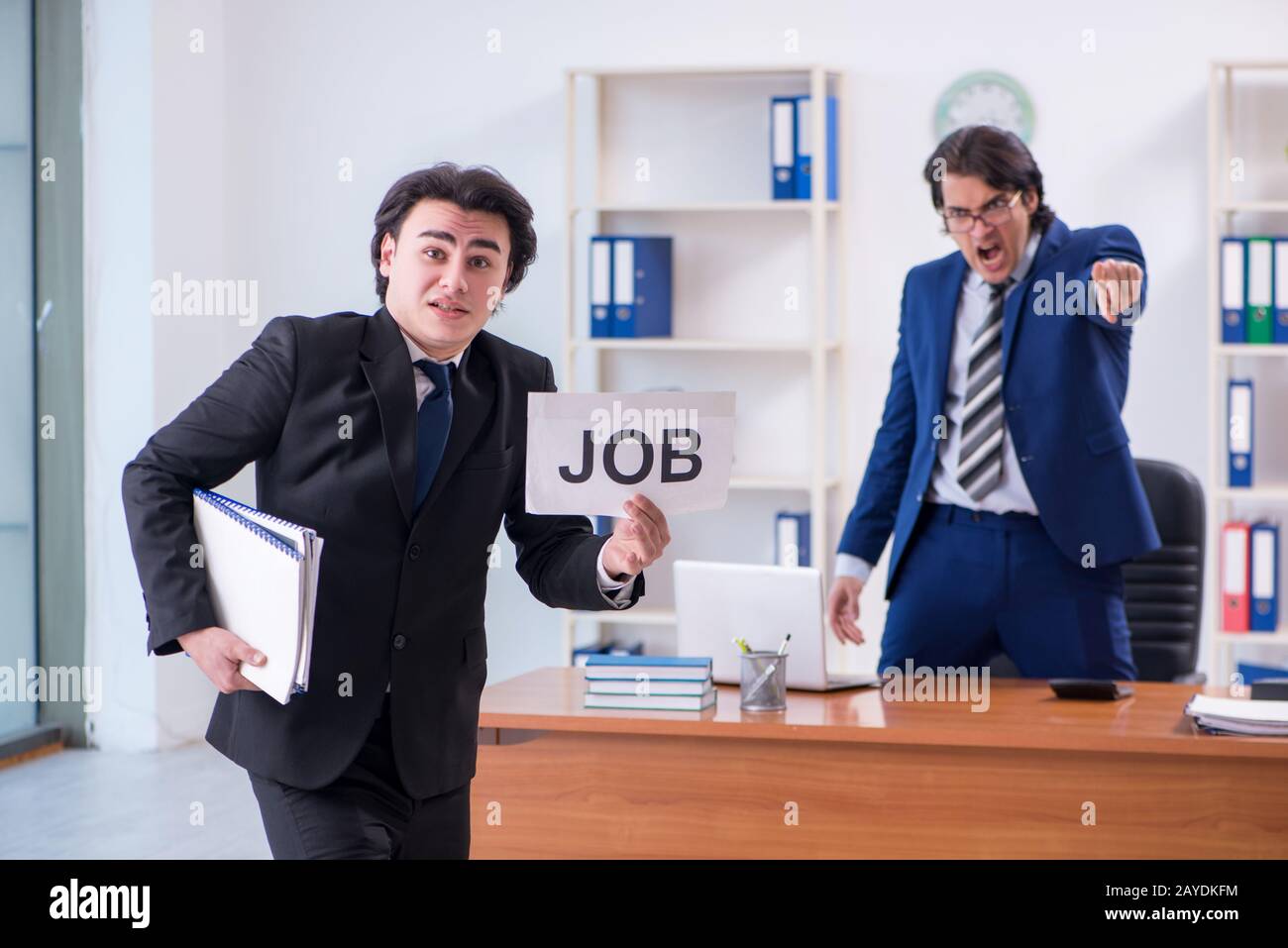 Boss and his male assistant working in the office Stock Photo - Alamy