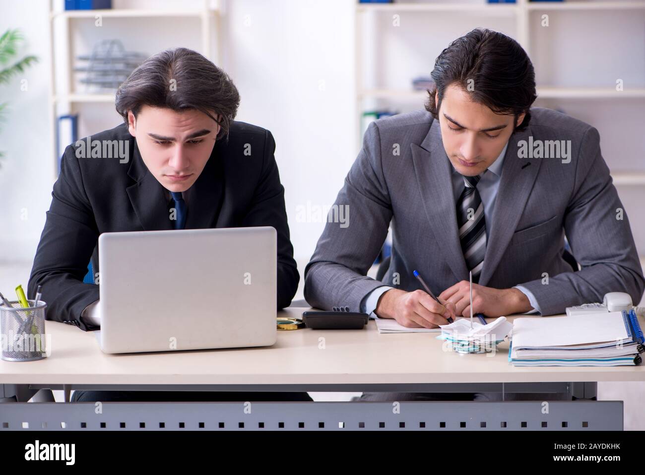 Two young employees working in the office Stock Photo - Alamy