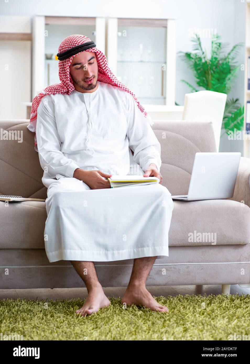 Arab man working at home on his work Stock Photo - Alamy