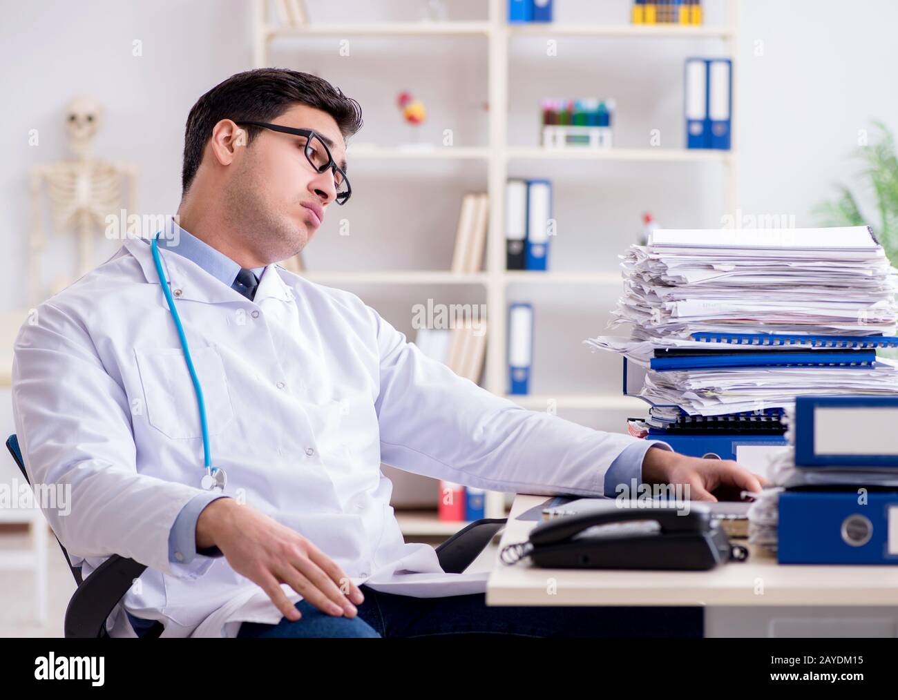 Busy doctor with too much work in hospital Stock Photo - Alamy