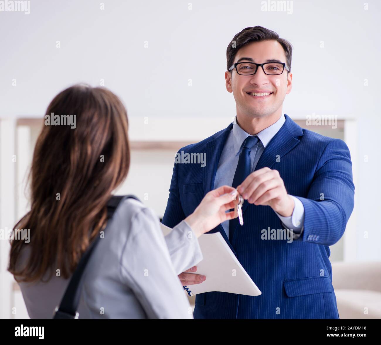Real estate agent showing new apartment to owner Stock Photo - Alamy