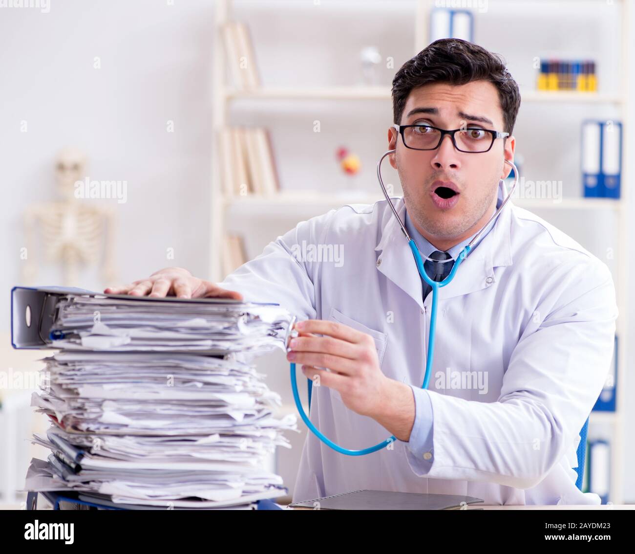 Busy doctor with too much work in hospital Stock Photo - Alamy