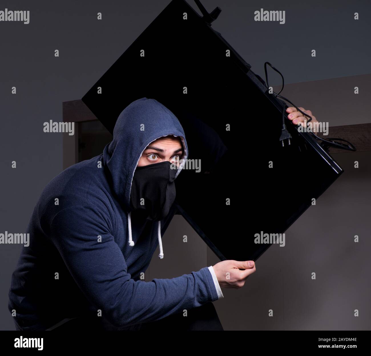 Burglar thief stealing tv from apartment house Stock Photo - Alamy