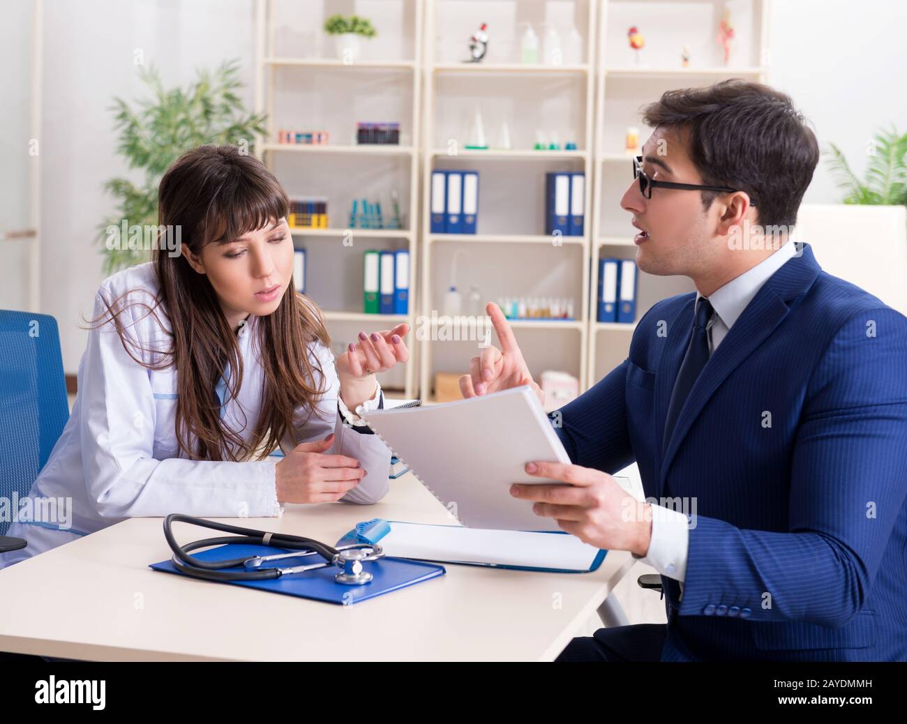 Man signing medical insurance contract Stock Photo - Alamy