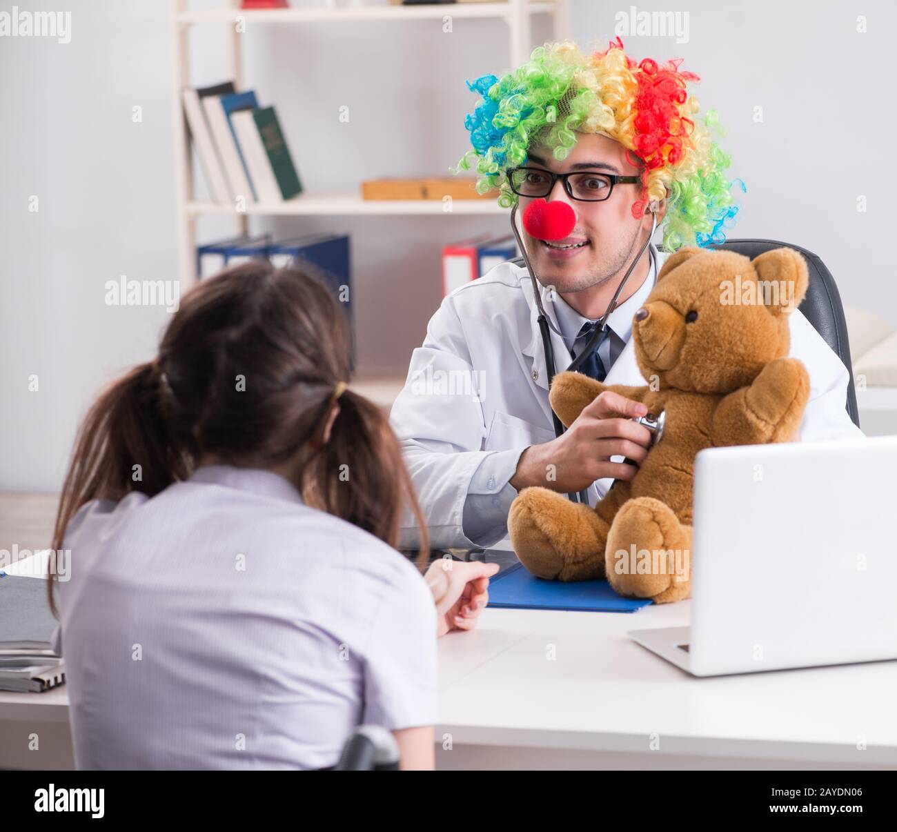 Funny pediatrician with little girl at regular check-up Stock Photo - Alamy
