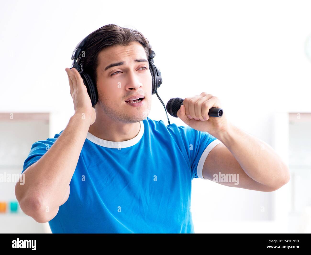 Young man singing at home karaoke Stock Photo - Alamy