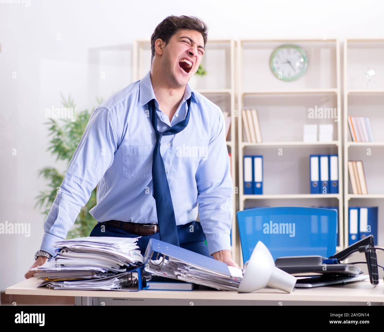 Angry businessman frustrated with too much work Stock Photo - Alamy