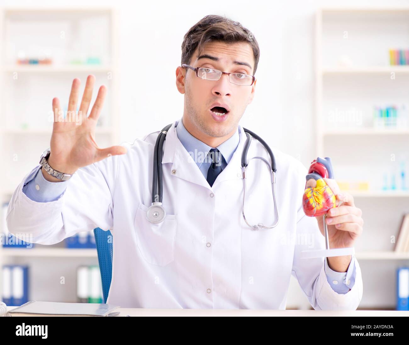 Doctor lecturer explaining the heart model Stock Photo - Alamy